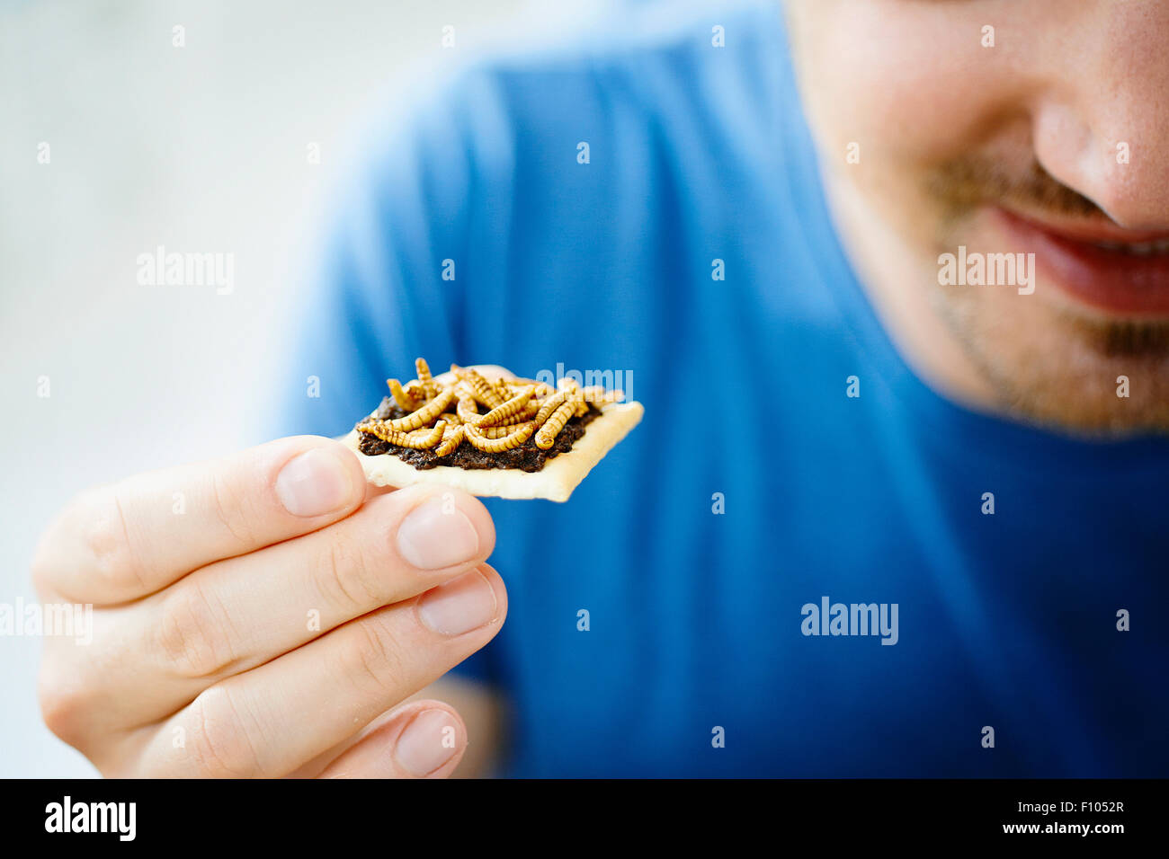 MAN EATING INSECT Stock Photo - Alamy