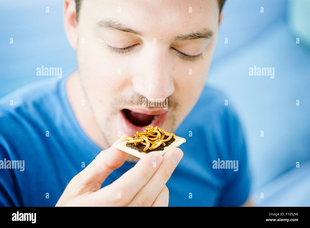 MAN EATING INSECT Stock Photo - Alamy