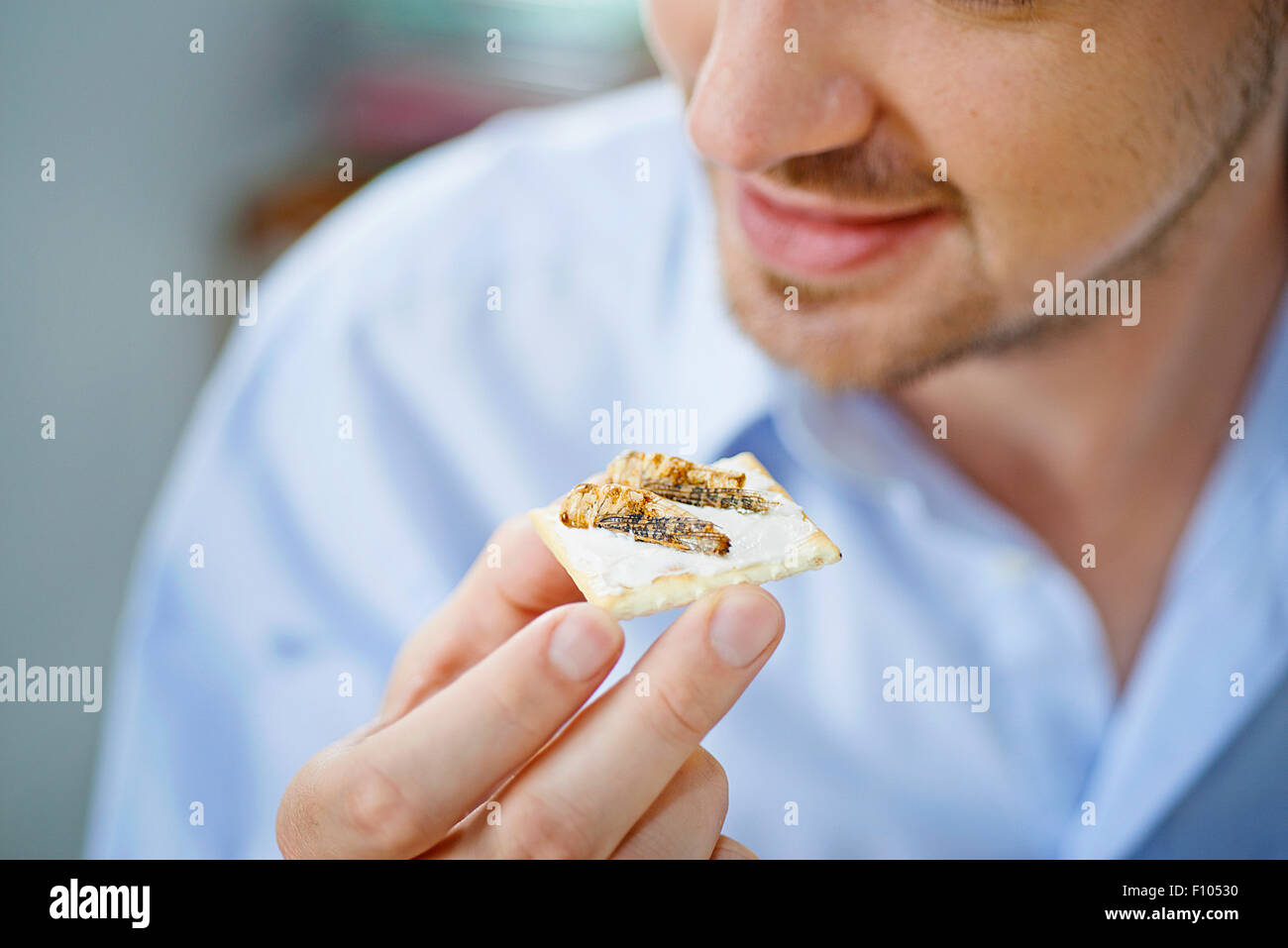 MAN EATING INSECT Stock Photo - Alamy