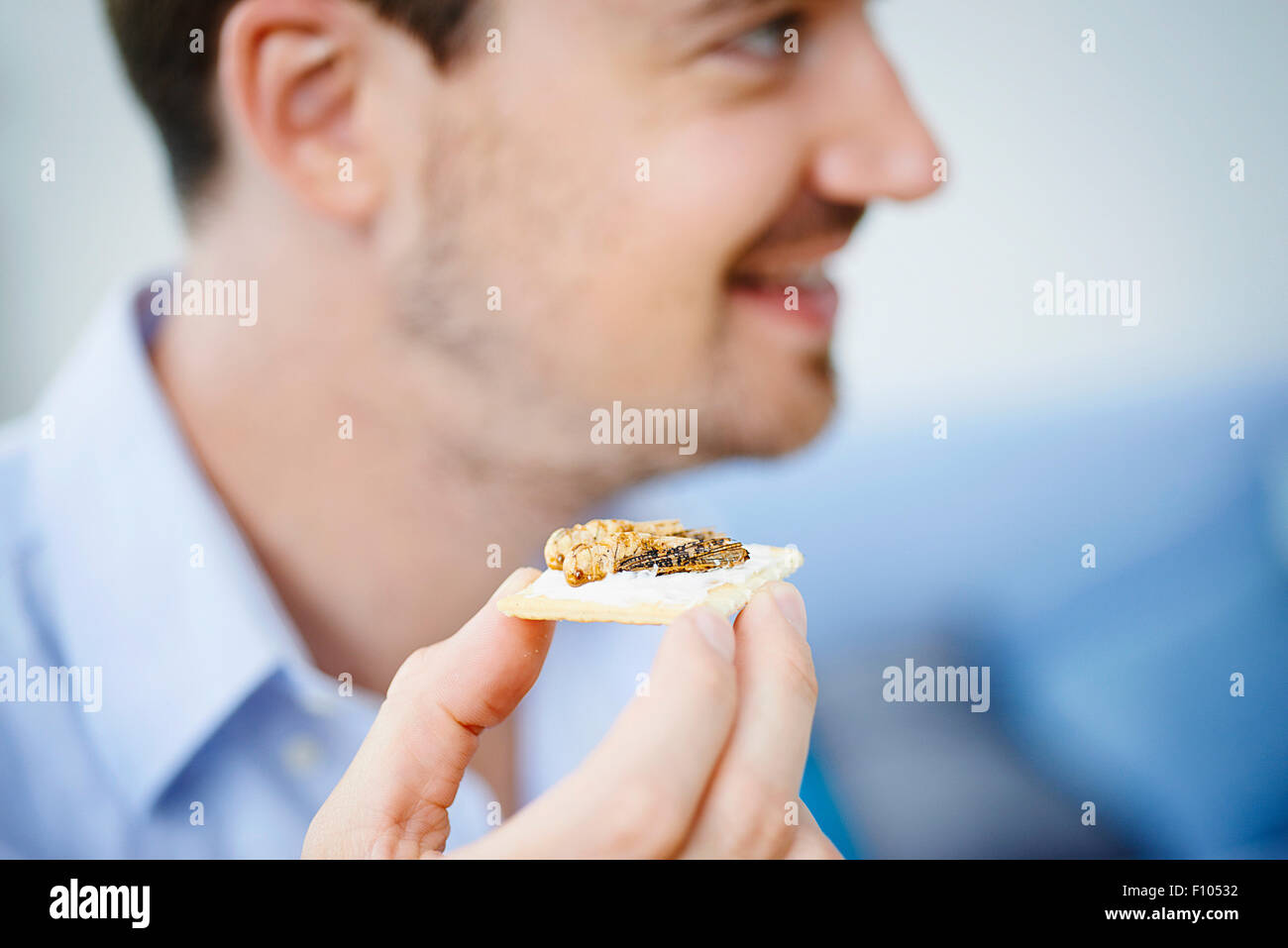MAN EATING INSECT Stock Photo - Alamy