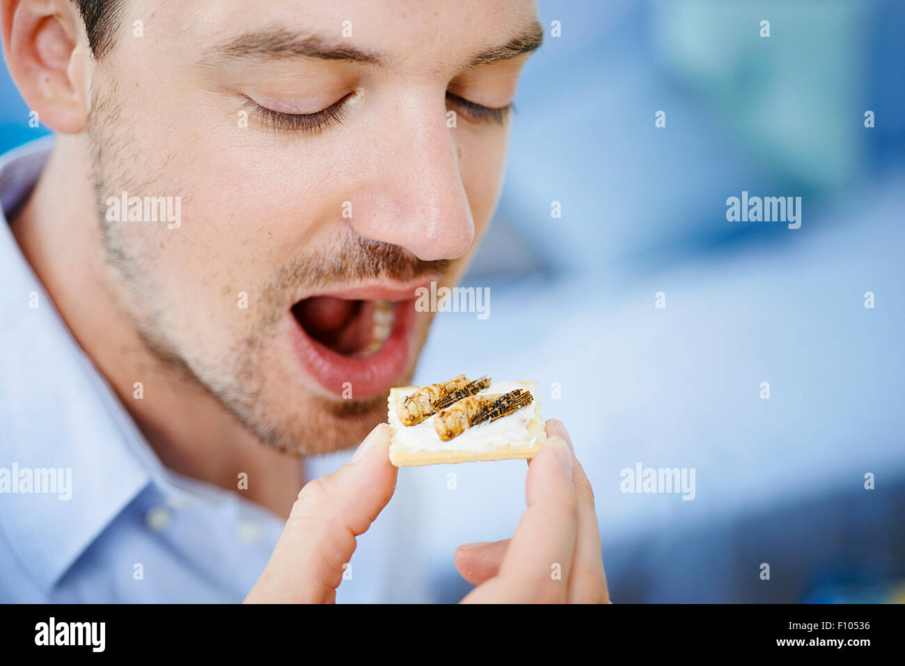 MAN EATING INSECT Stock Photo - Alamy