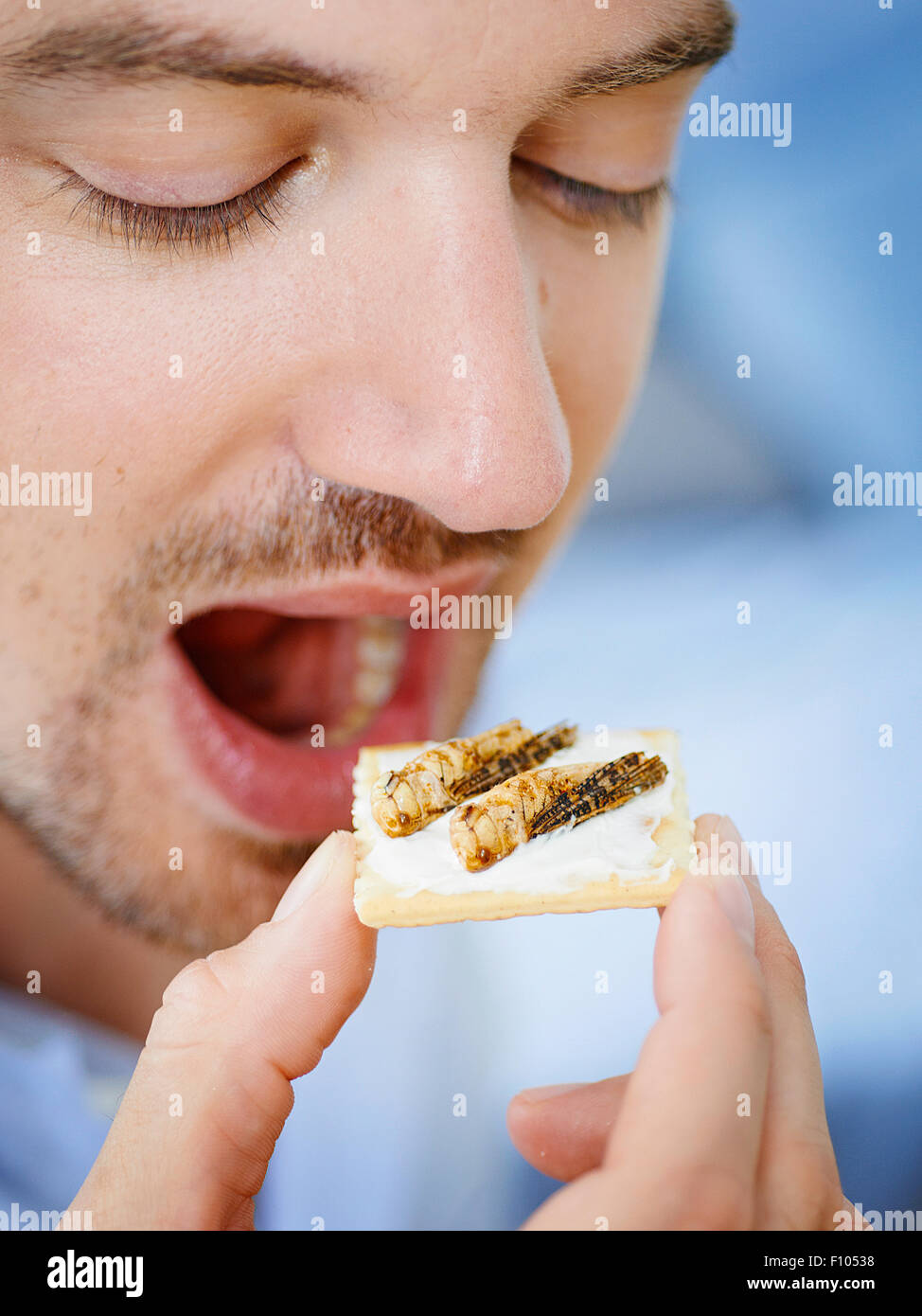 MAN EATING INSECT Stock Photo - Alamy