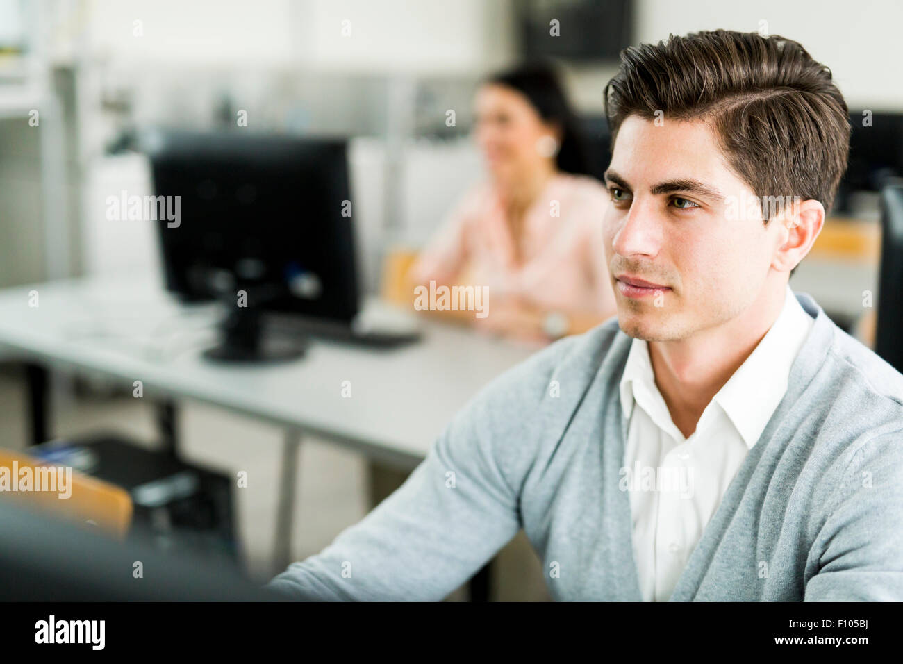 Young handsome man studying information technology in a classroom Stock ...