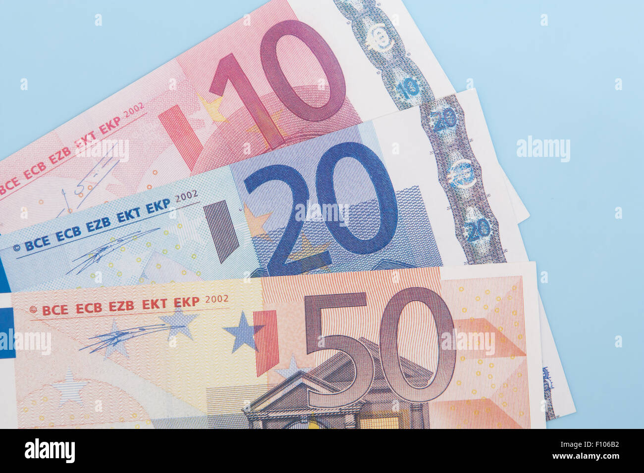 Eighty euro in various notes on light blue background Stock Photo - Alamy