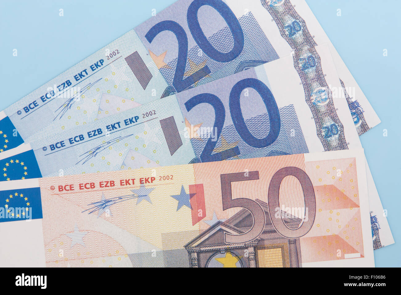 Ninety euro in various notes on light blue background Stock Photo - Alamy