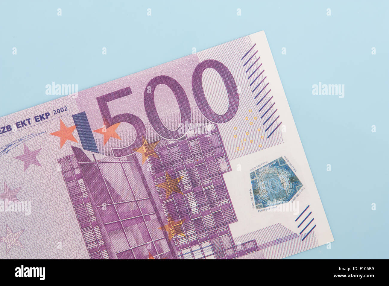 Single 500 euro note on light blue background Stock Photo - Alamy