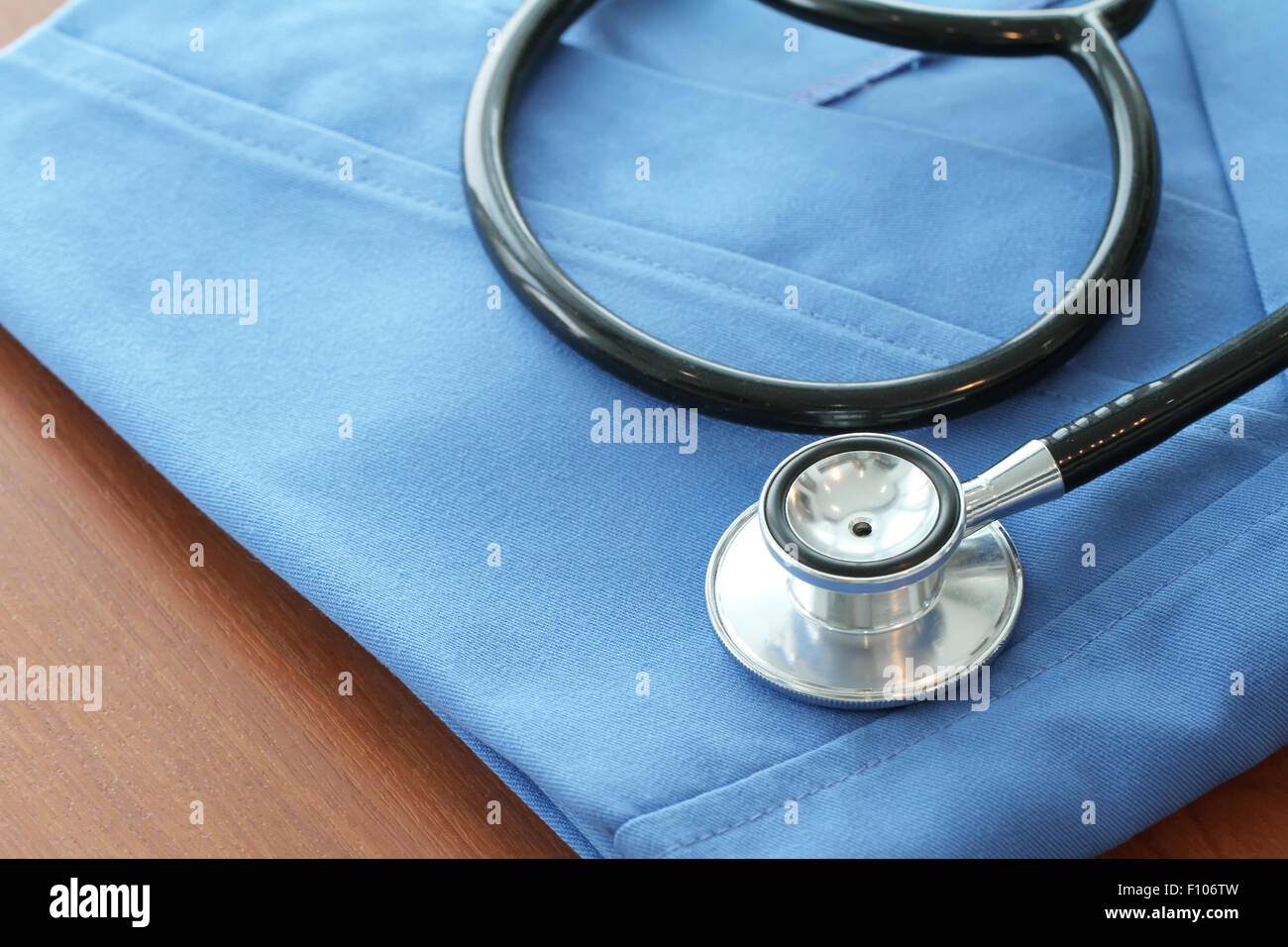 Stethoscope with blue doctor coat on wooden table and background Stock ...