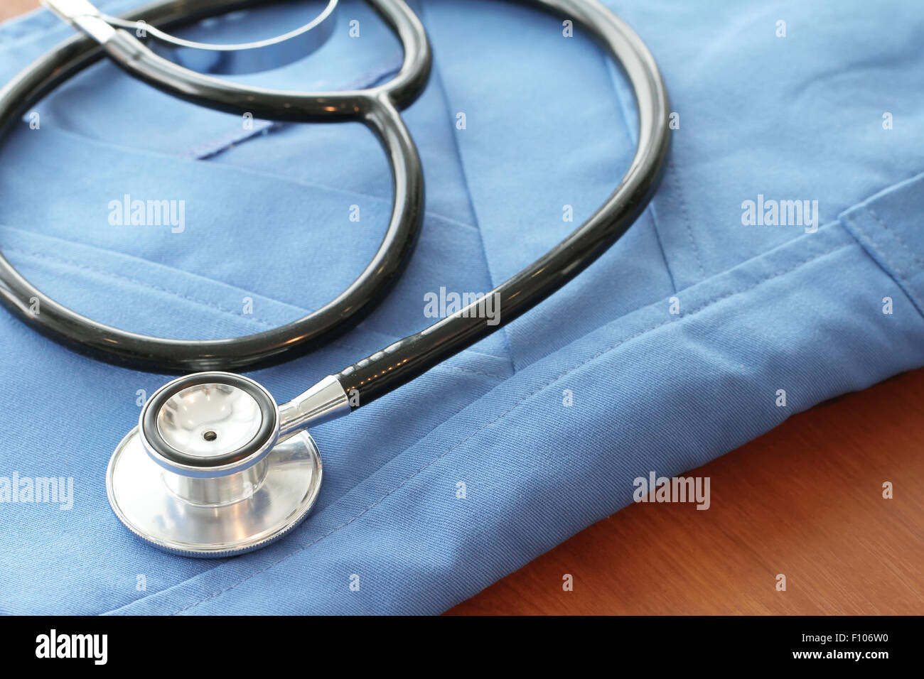 Stethoscope with blue doctor coat on wooden table and background Stock ...