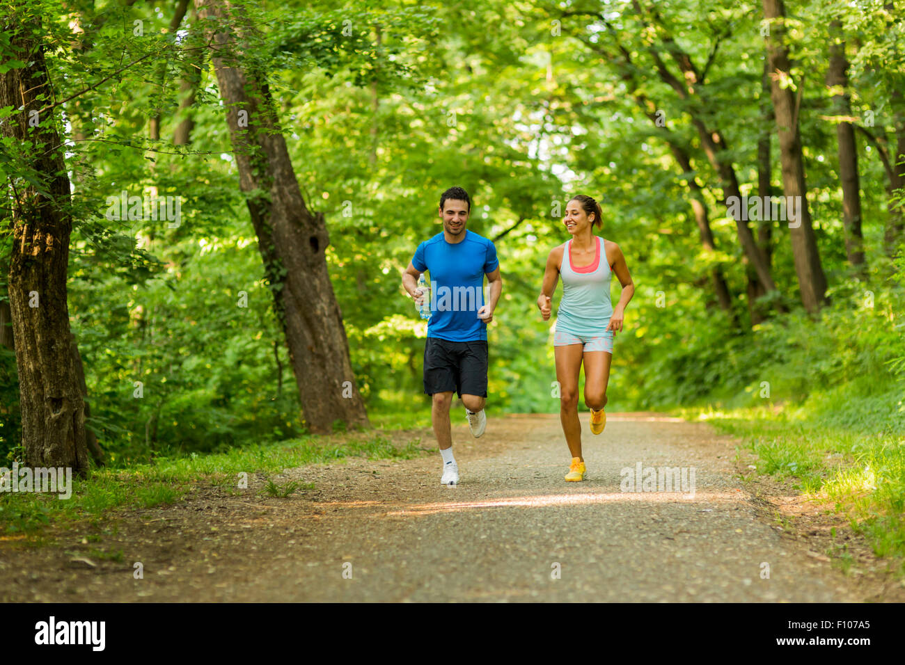 Young people jogging and exercising in nature Stock Photo - Alamy