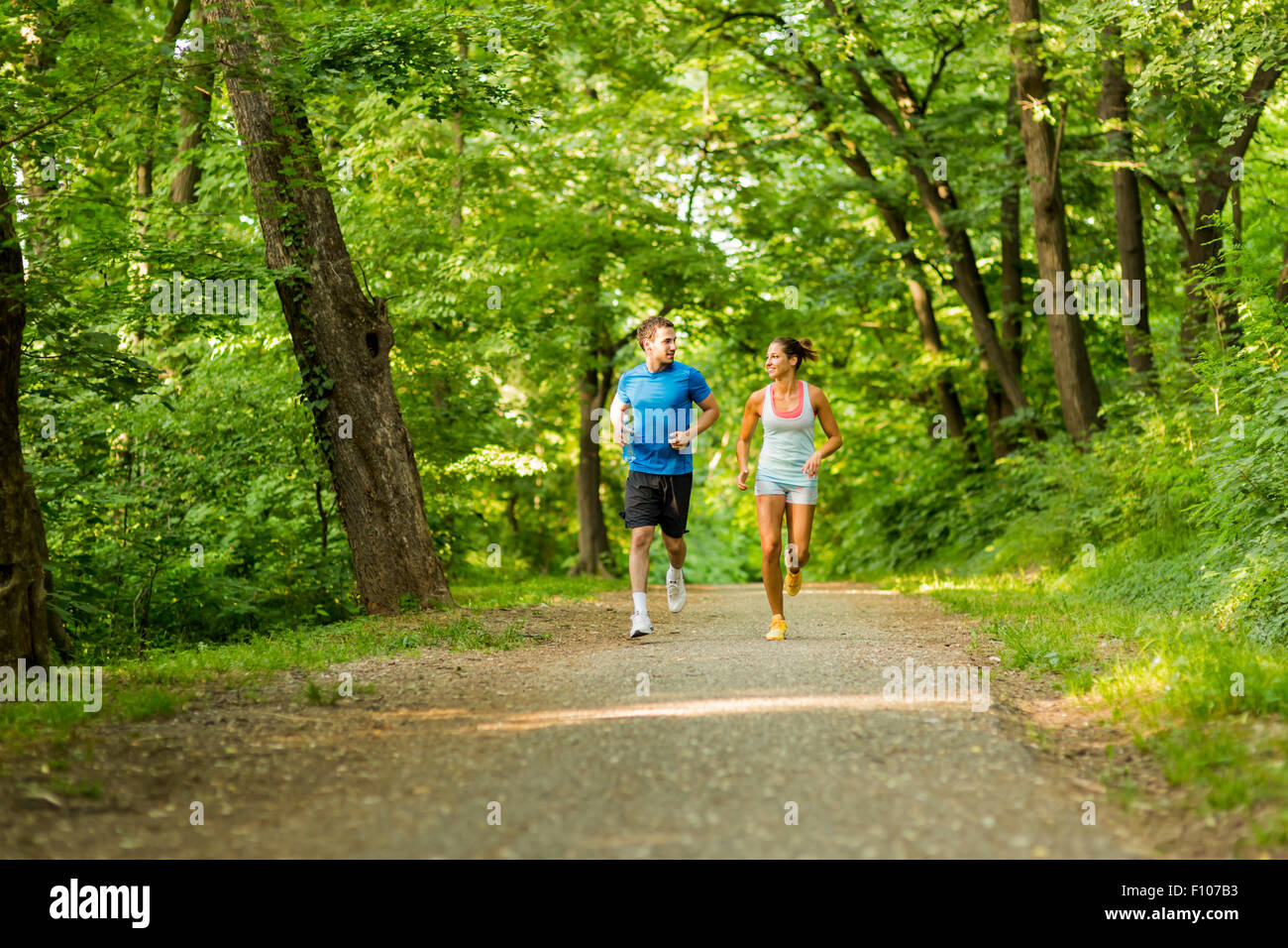 Young people jogging and exercising in nature Stock Photo - Alamy