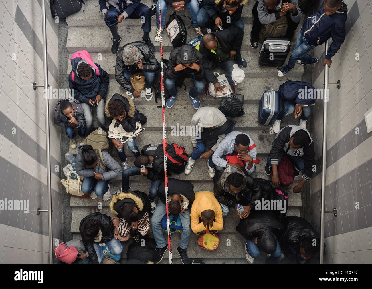 Refugees sit on stairs in Rosenheim, Germany, 19. August 2015. Many ...