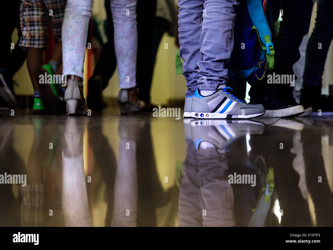 A refugee who wears new looking shoes stands in a hallway in Bozen ...