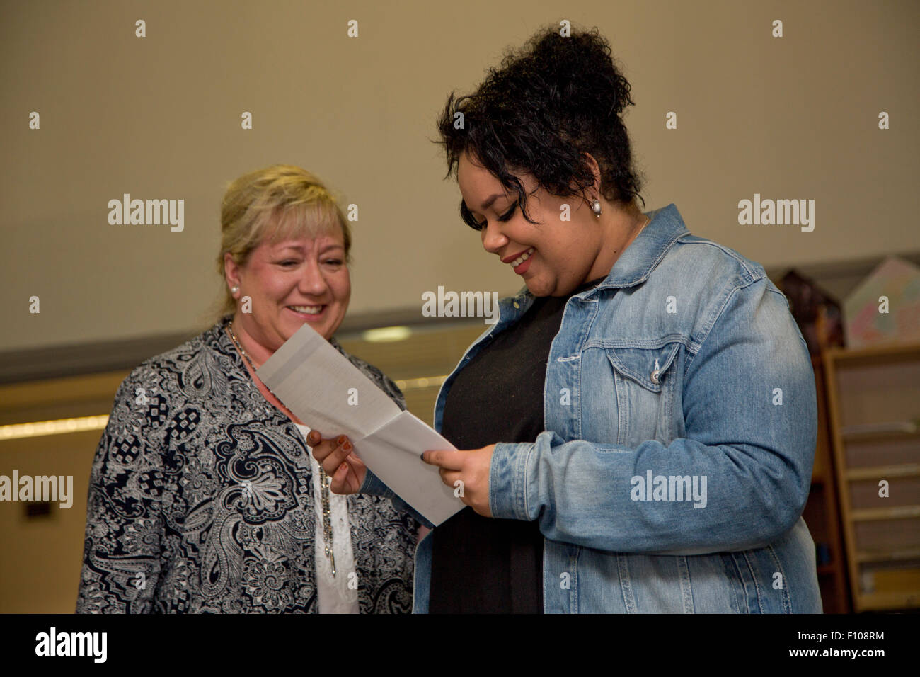 Students getting their results from teacher Stock Photo - Alamy