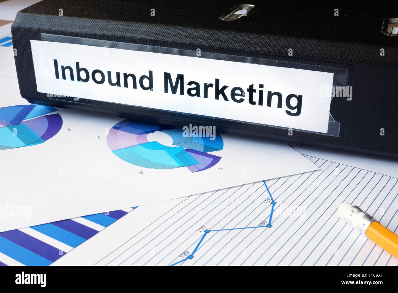 Graphs and file folder with label Inbound Marketing. Business concept ...