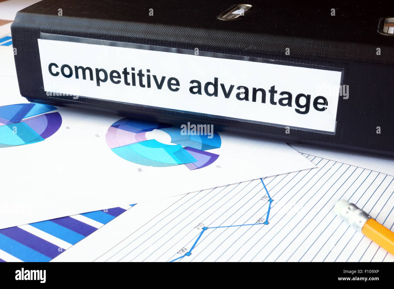 Graphs and file folder with label competitive advantage. Business ...