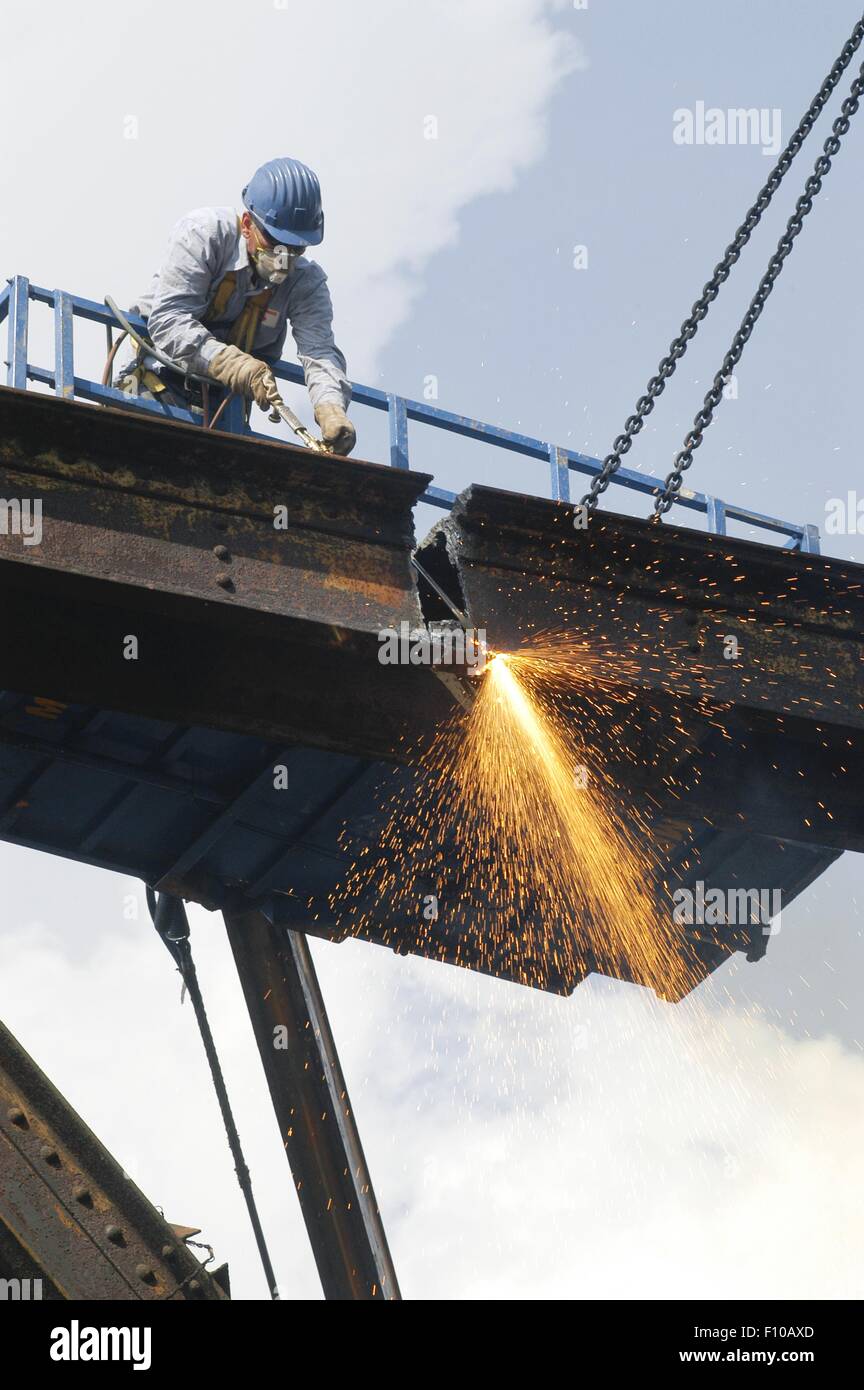 demolition of an old railway iron bridge with plasma cutting flame ...