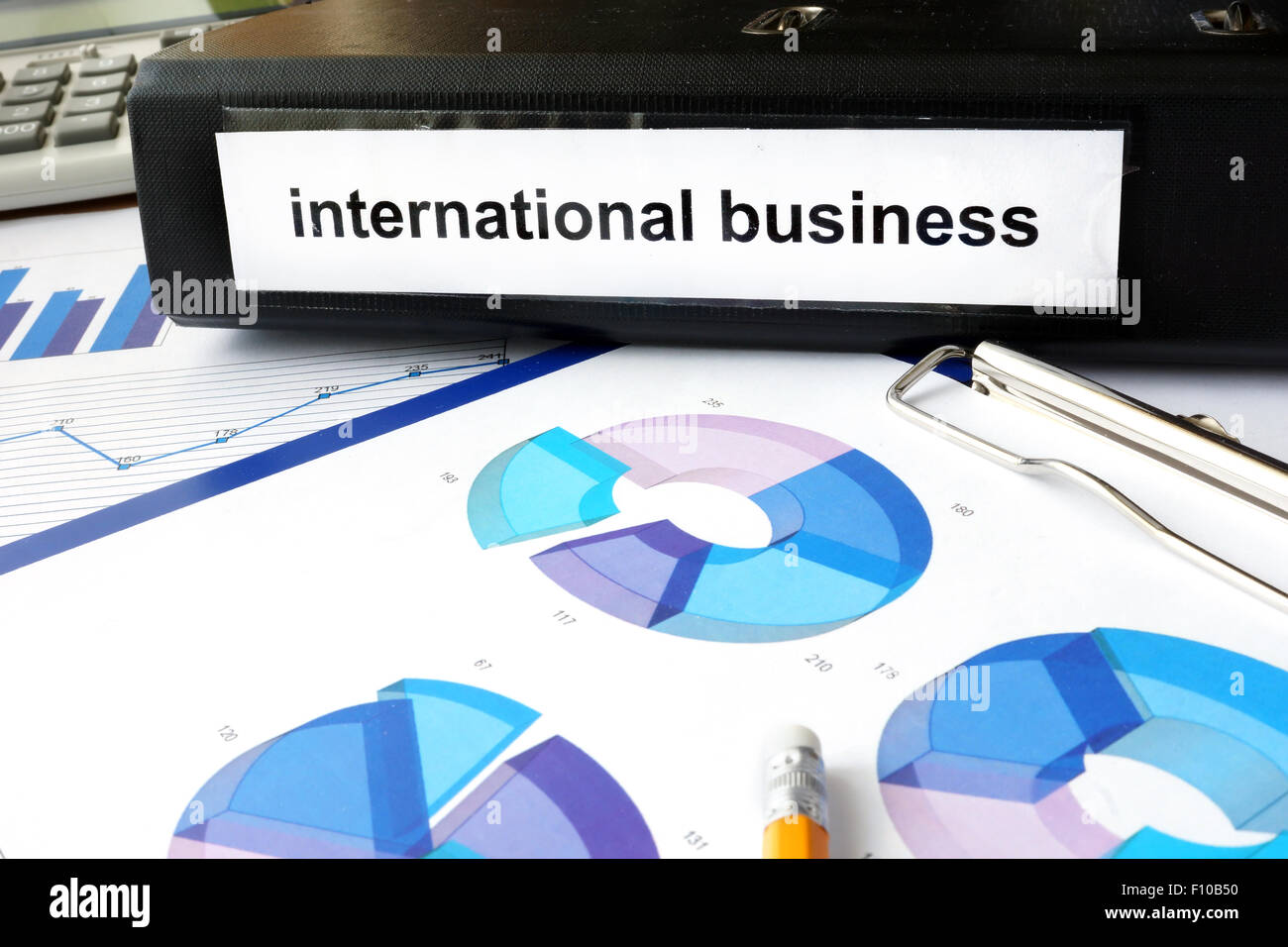 Folder with the label international business and charts Stock Photo - Alamy
