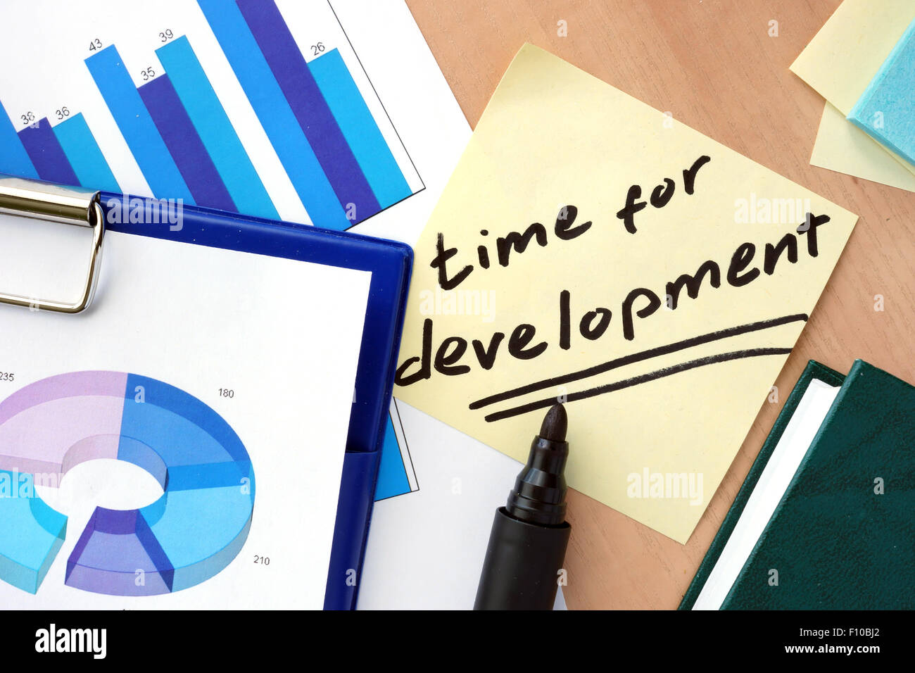 Paper with words time for development and charts Stock Photo - Alamy