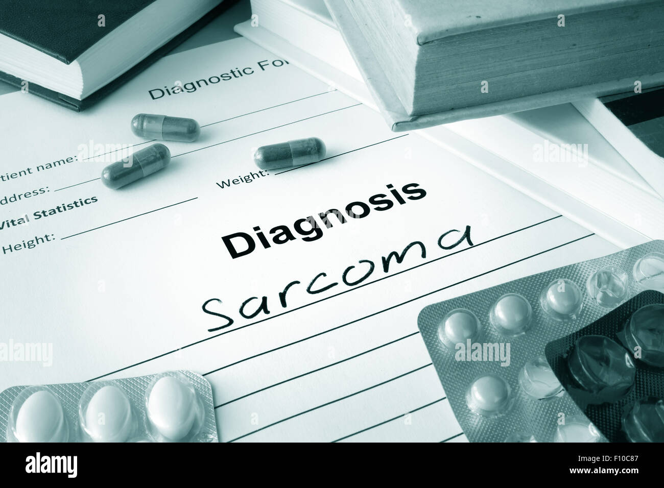 Diagnostic form with diagnosis sarcoma and pills Stock Photo - Alamy