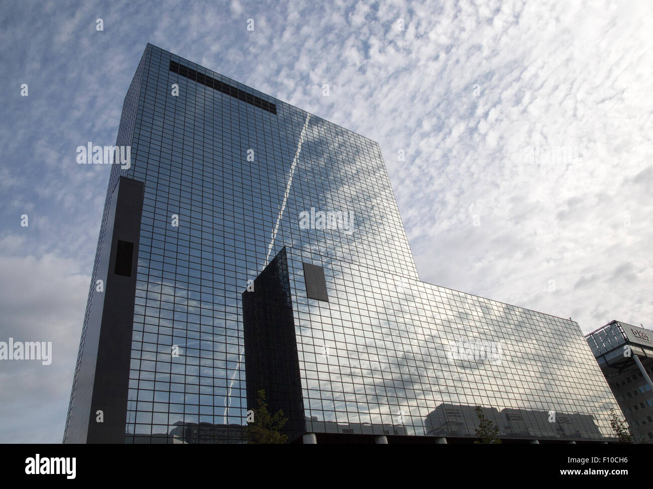 High rise modern glass office block buildings reflecting clouds ...
