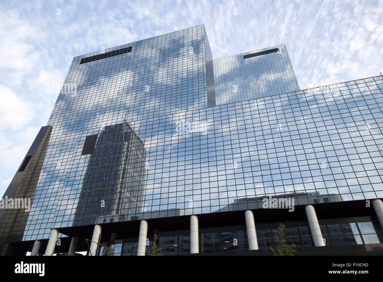 High rise modern glass office block buildings reflecting clouds ...