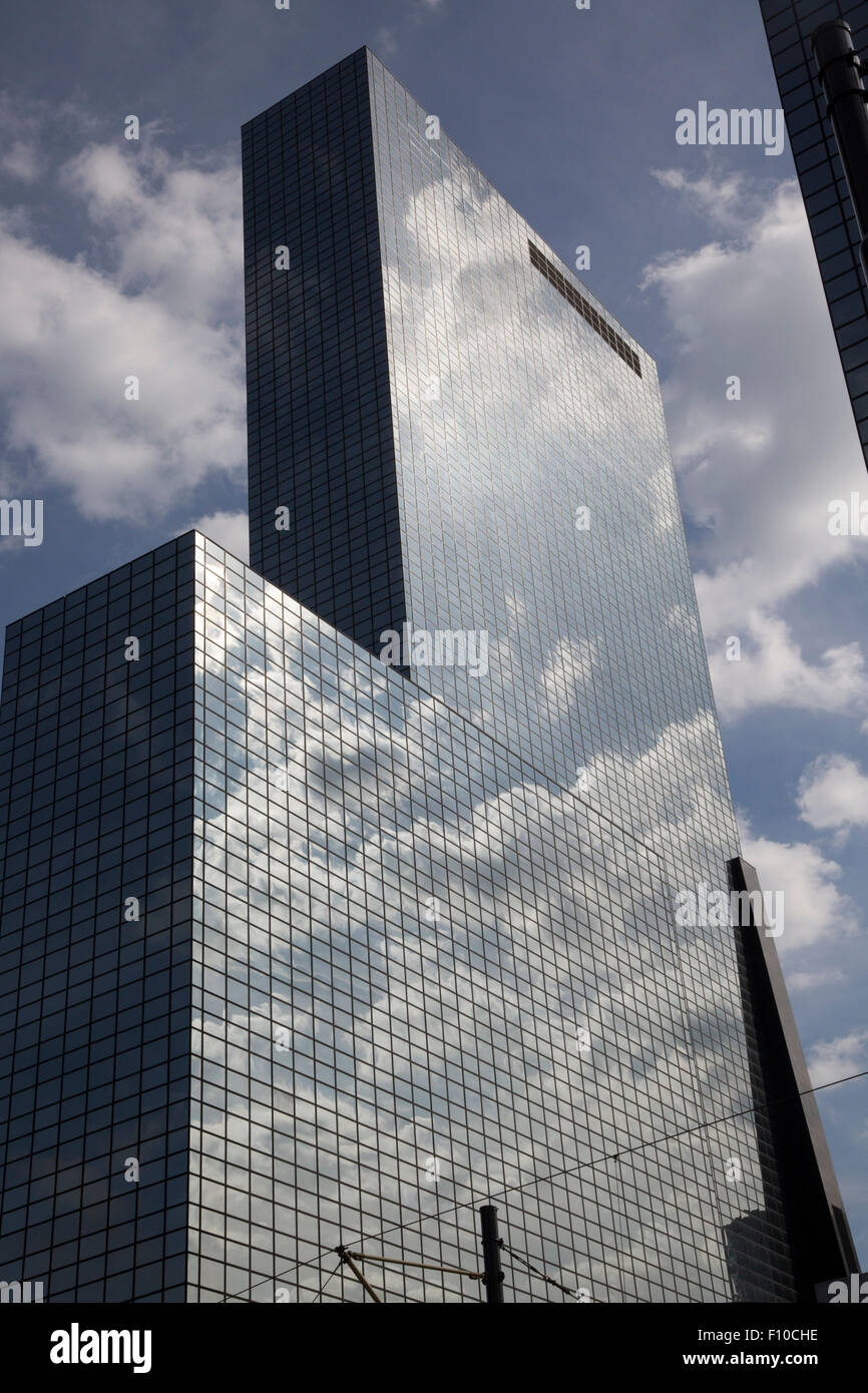 High rise modern glass office block buildings reflecting clouds ...