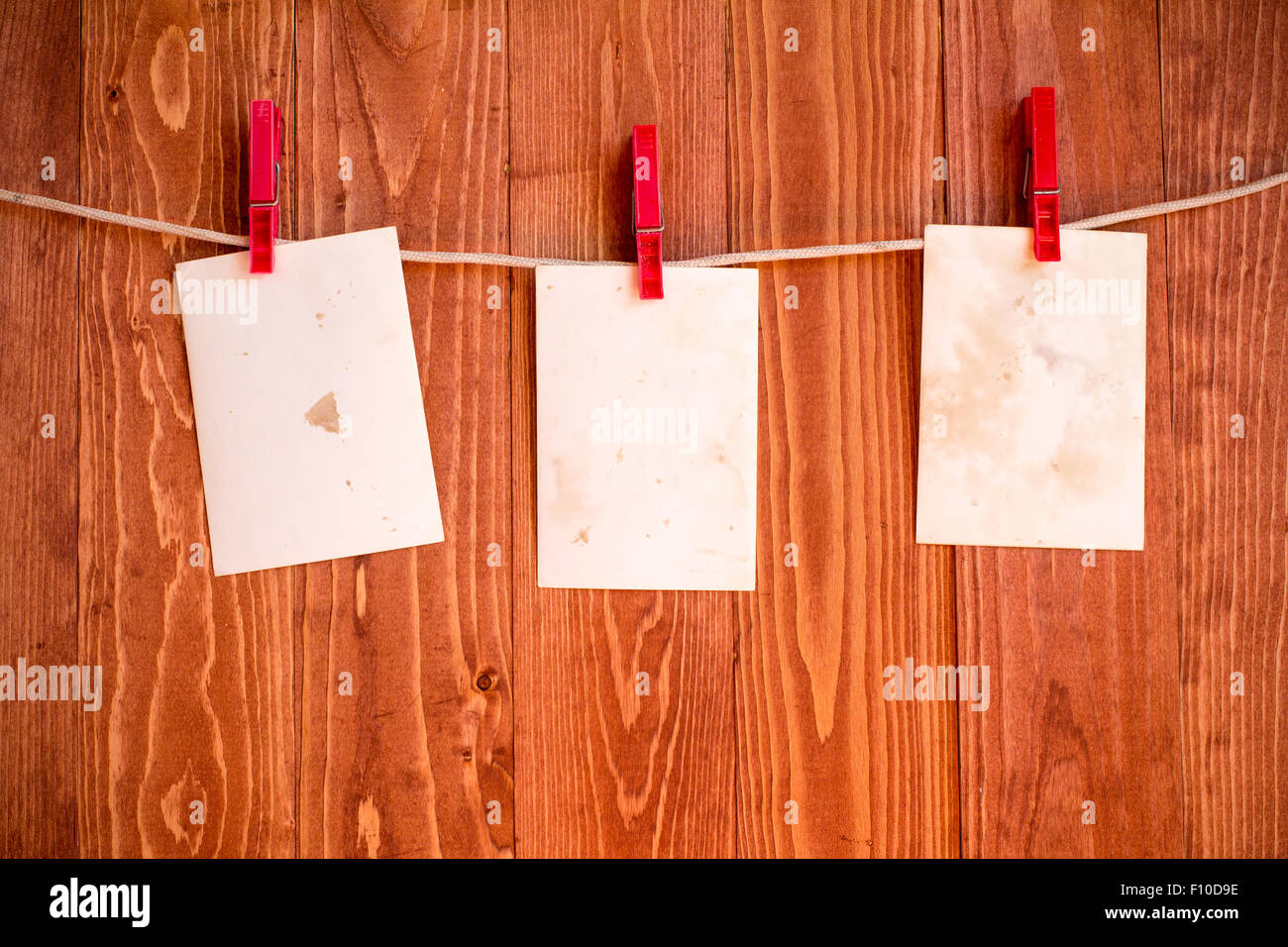 Photo frames hanging on a rope over wooden background Stock Photo - Alamy