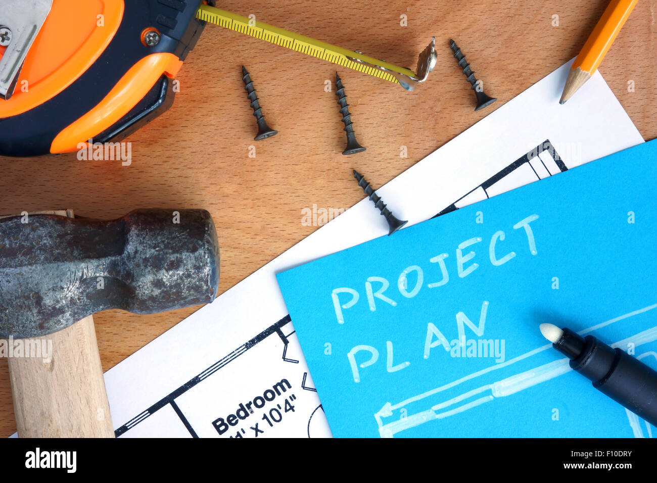 Blue paper with home improvement project plan, tools kit on a wood ...