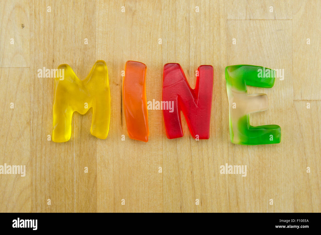 Multi colored gummy letters spell the word mine Stock Photo - Alamy
