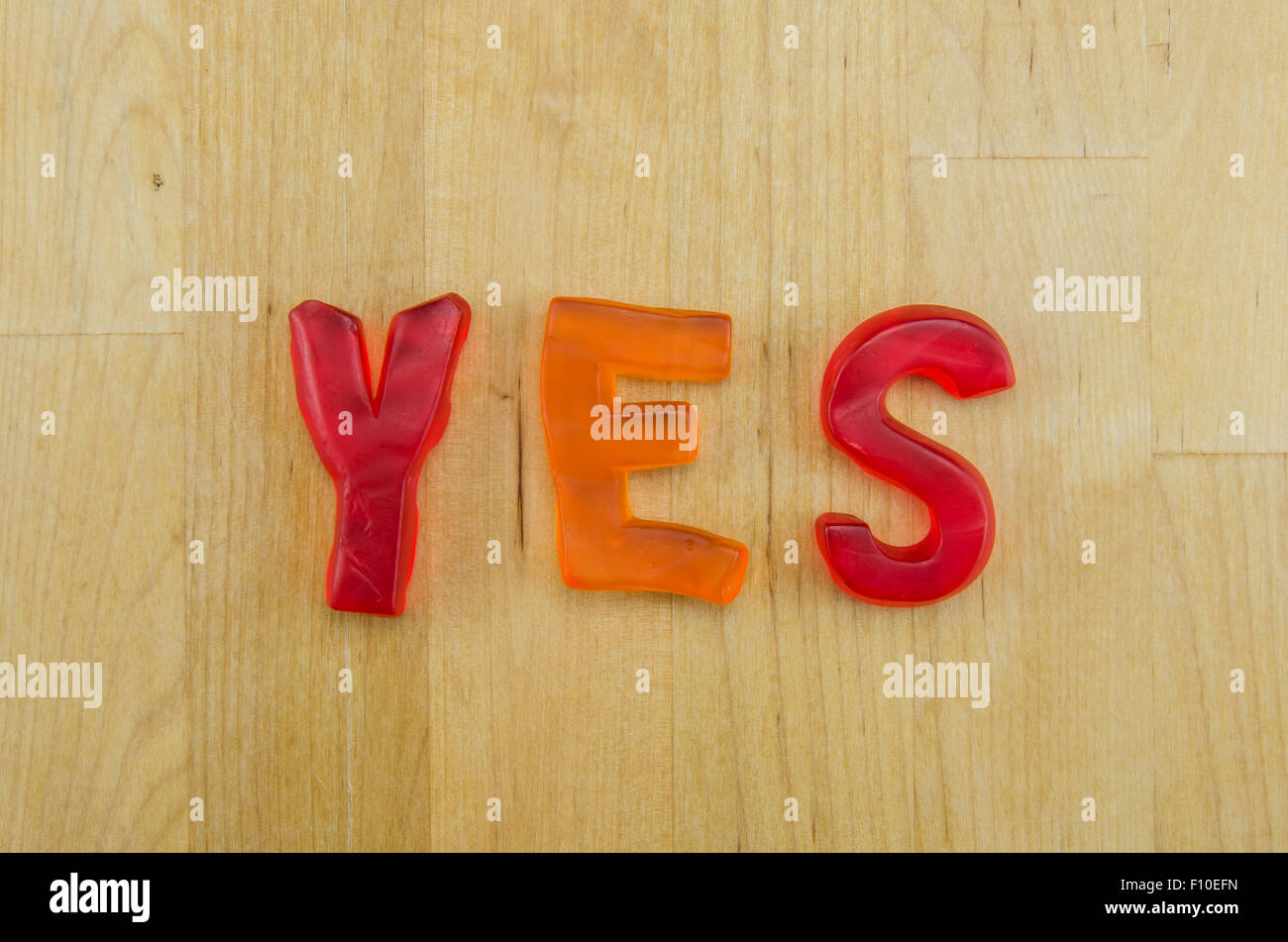 Red and orange gummy letters spell the word yes Stock Photo - Alamy