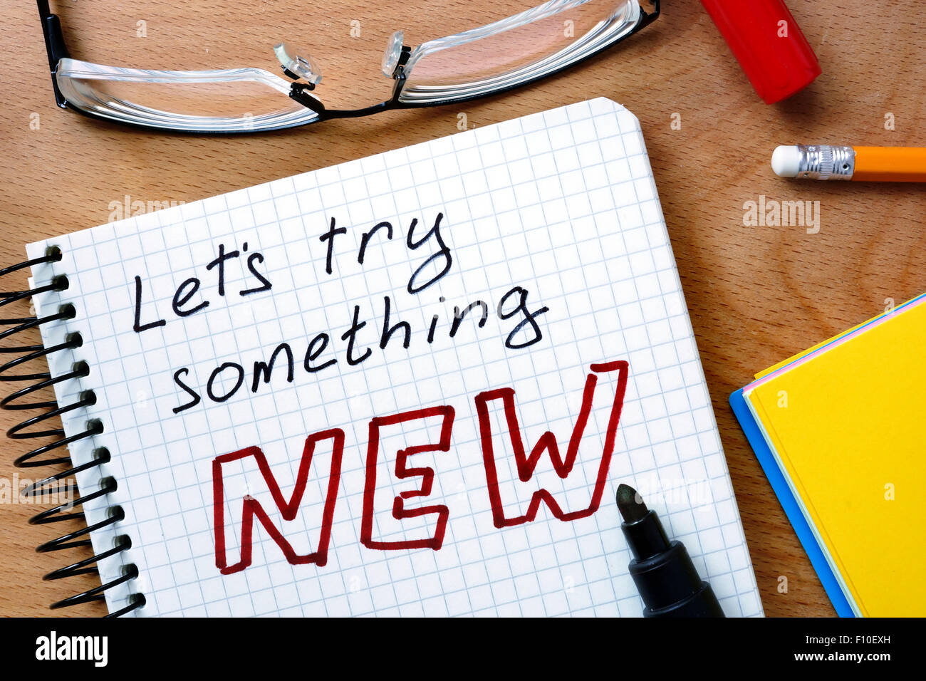 Notepad with let’s try something new on office wooden table Stock Photo ...