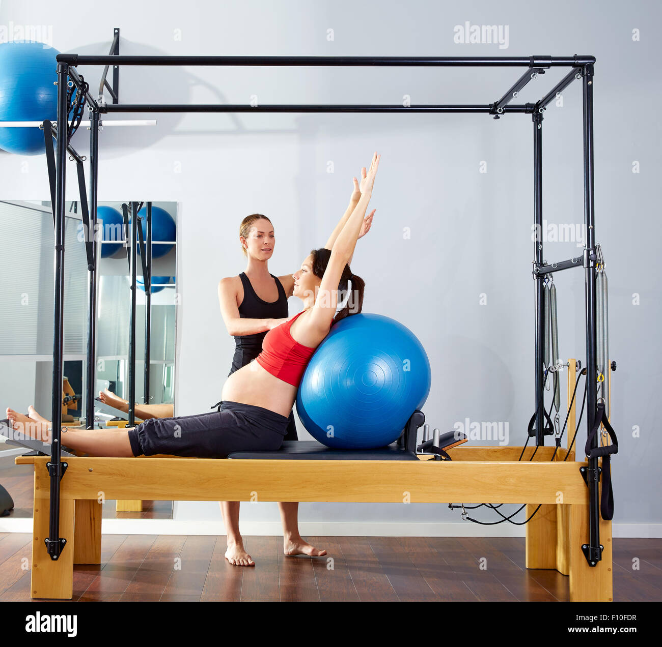 pregnant woman pilates reformer cadillac fitball exercise workout with ...