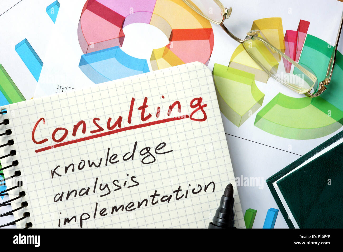 Consulting word written on the notepad and chart Stock Photo - Alamy