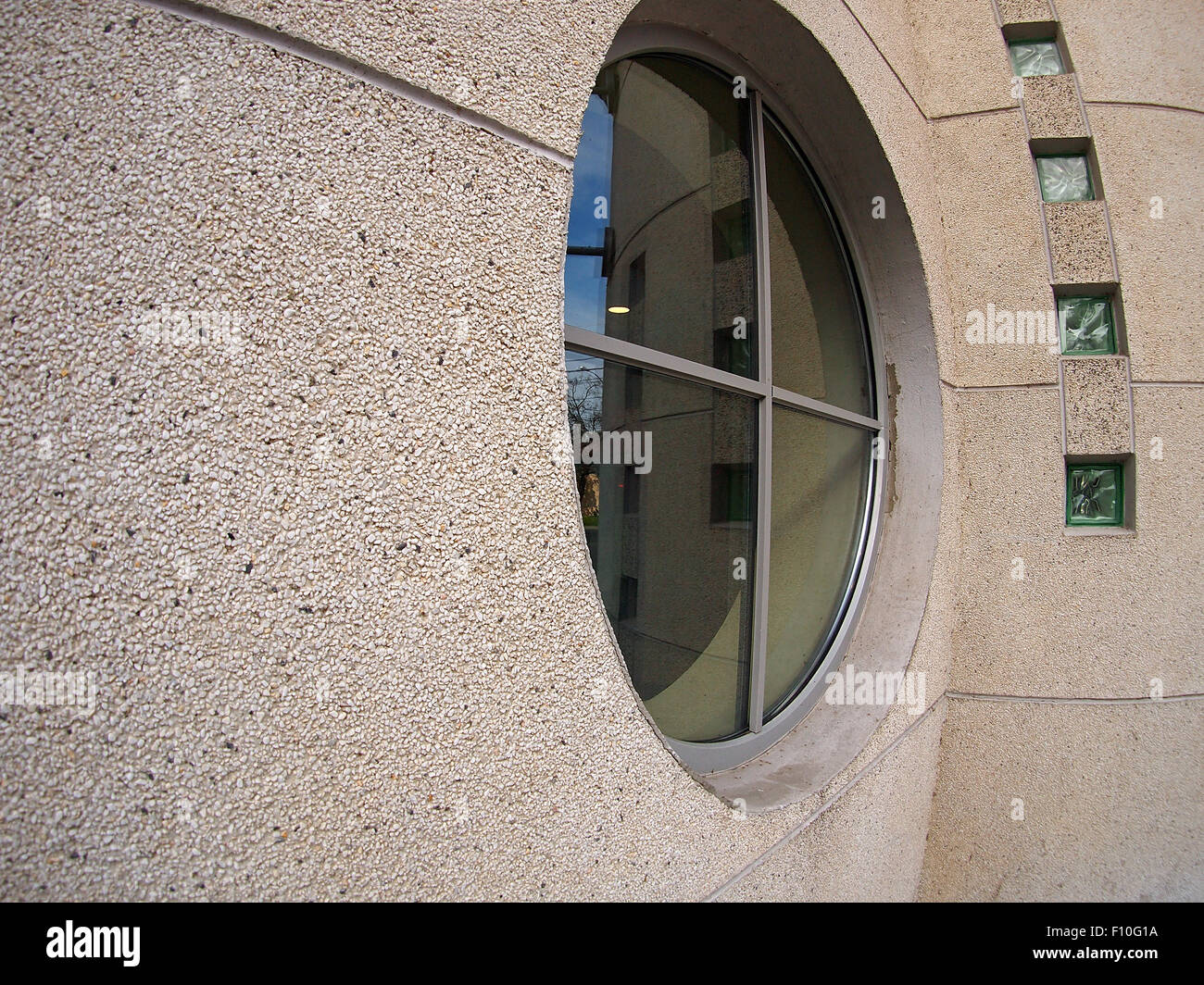 Detail of a wall of an office building with a round window with wide ...