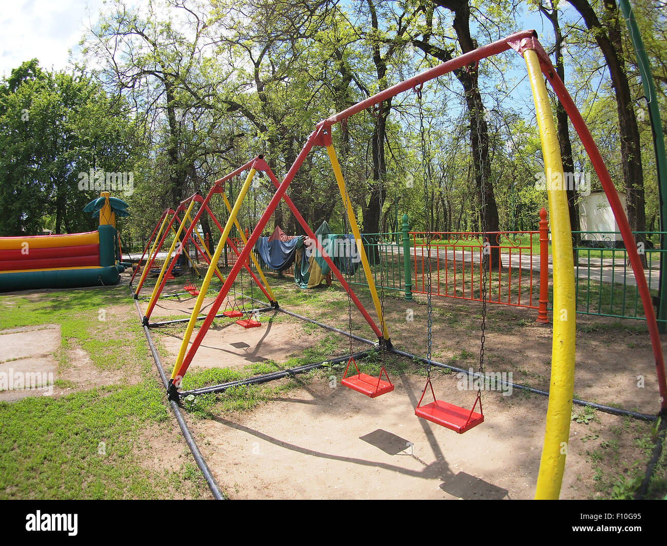 Children's playground with swings in the park - wide angle distortion ...