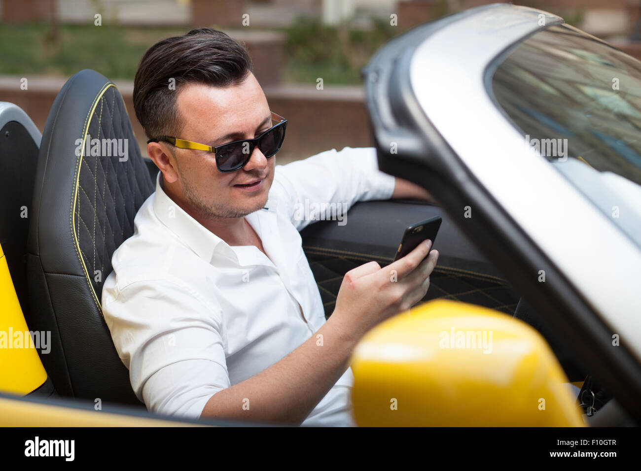 Driver man using smartphone in car Stock Photo - Alamy