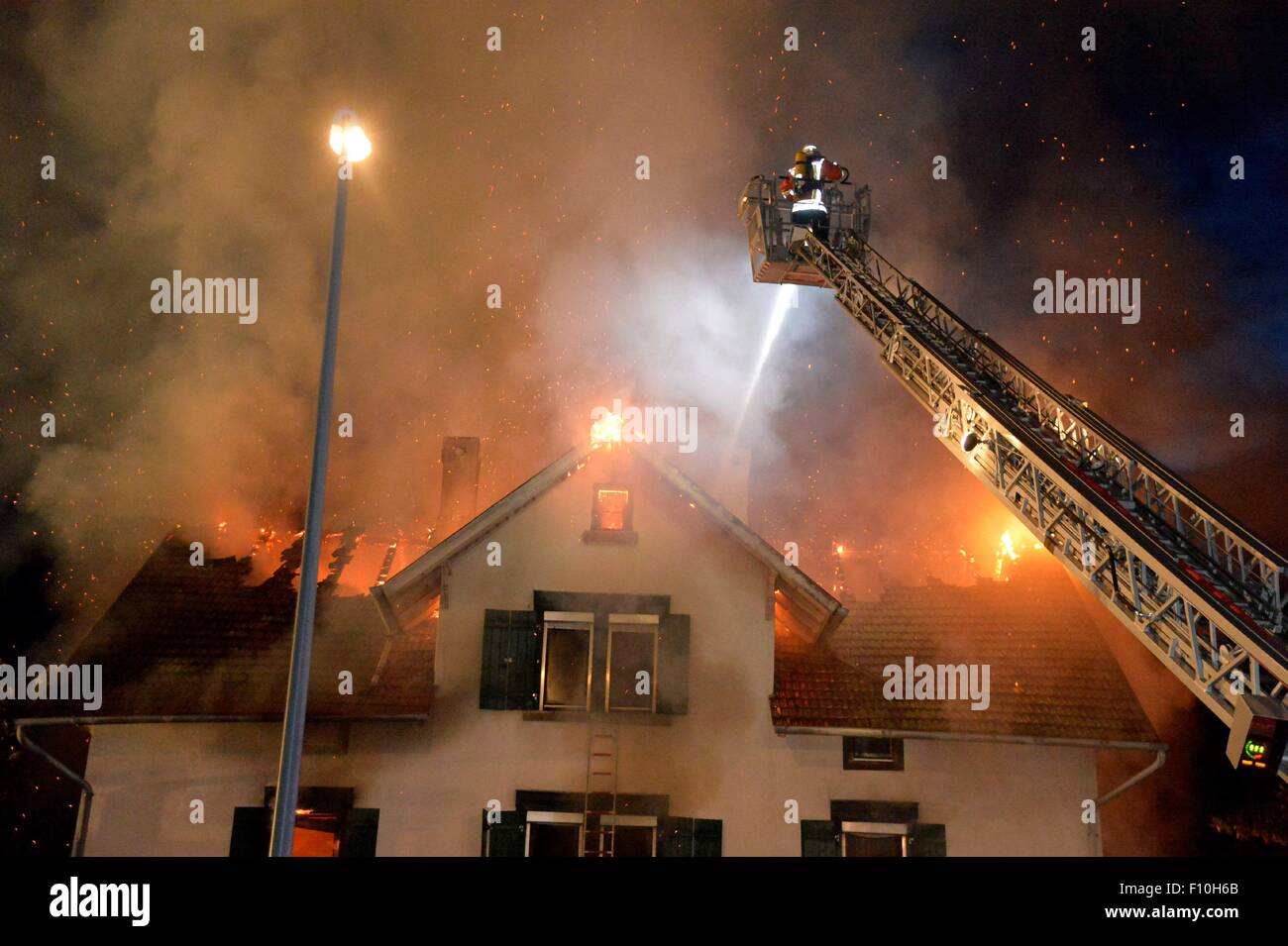Fire fighters extinguish a fire in an empty building in Weissach im Tal ...