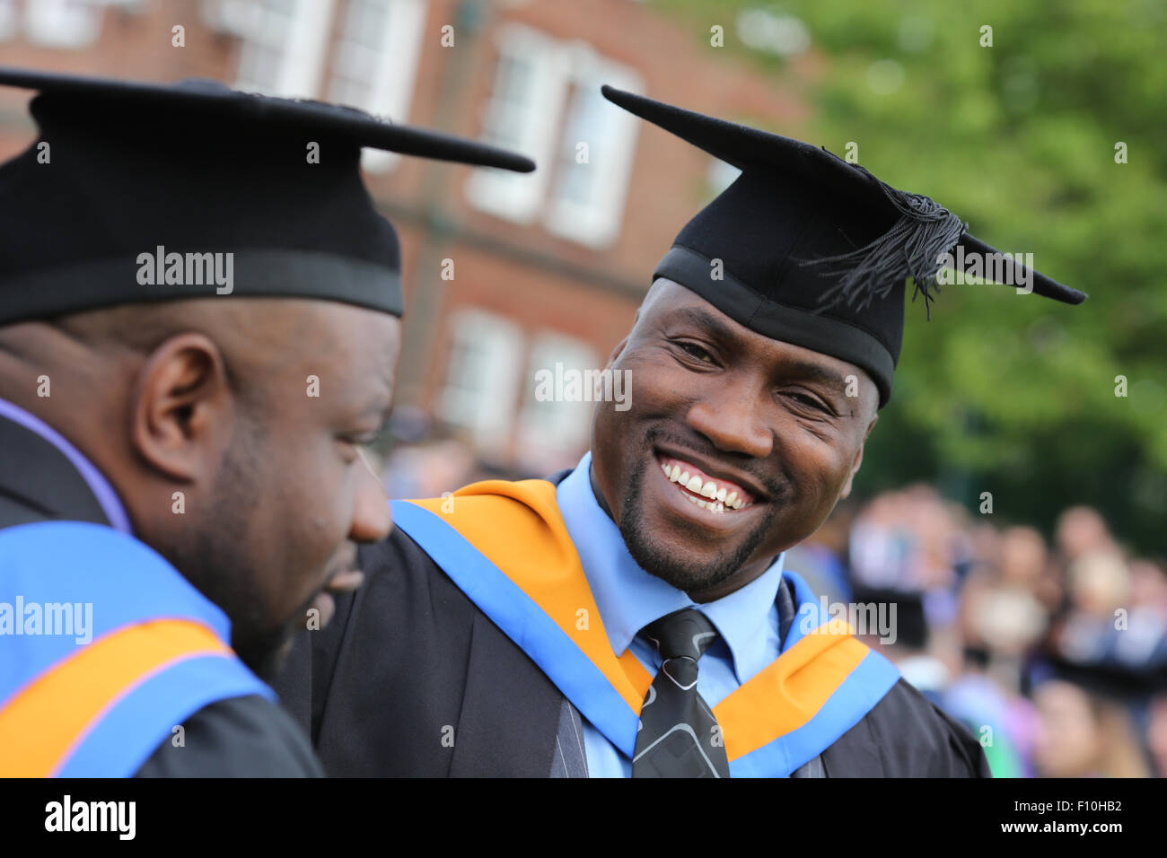 male students smiling after University graduation ceremony Stock Photo ...