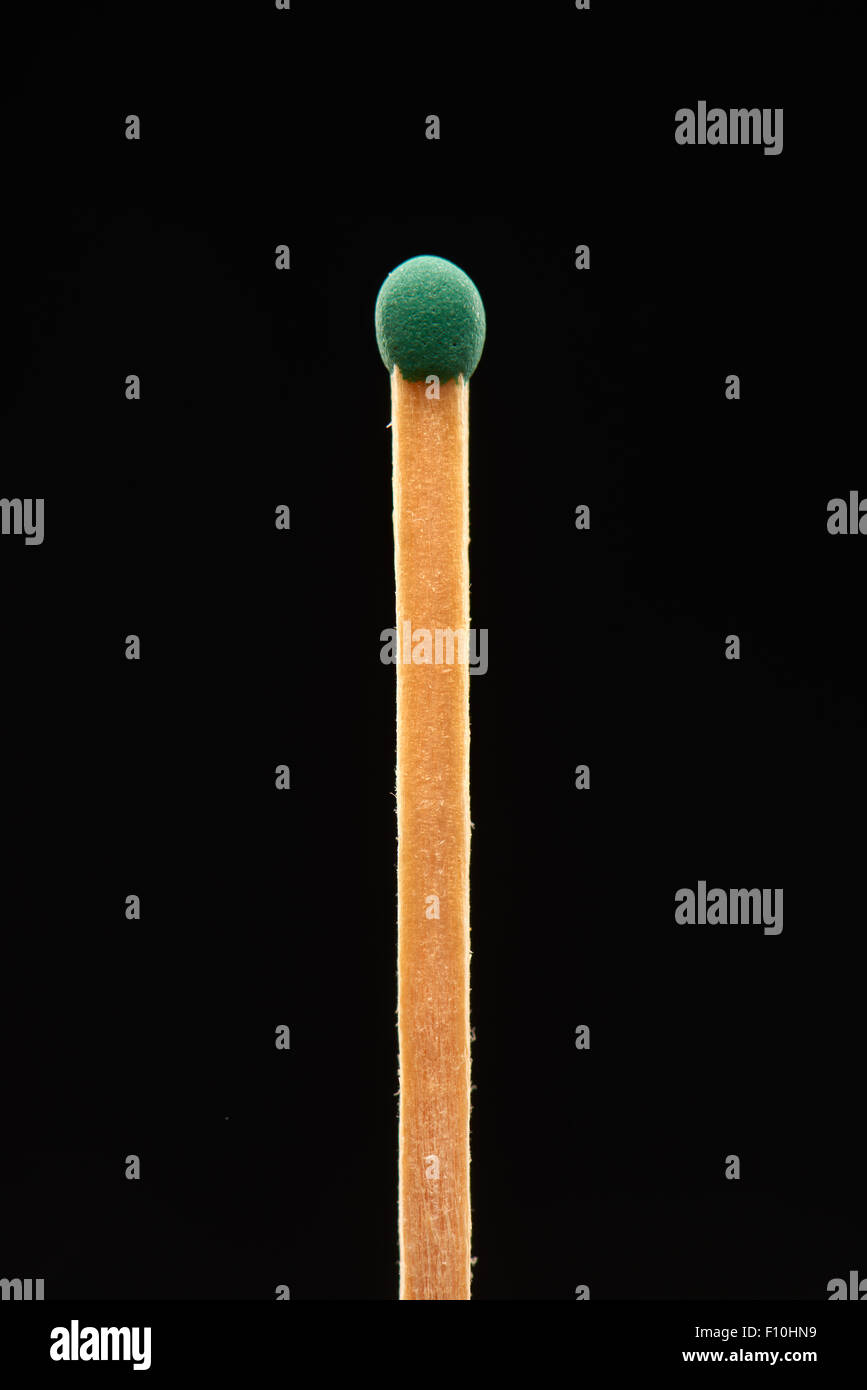 Green match isolated on black background Stock Photo - Alamy