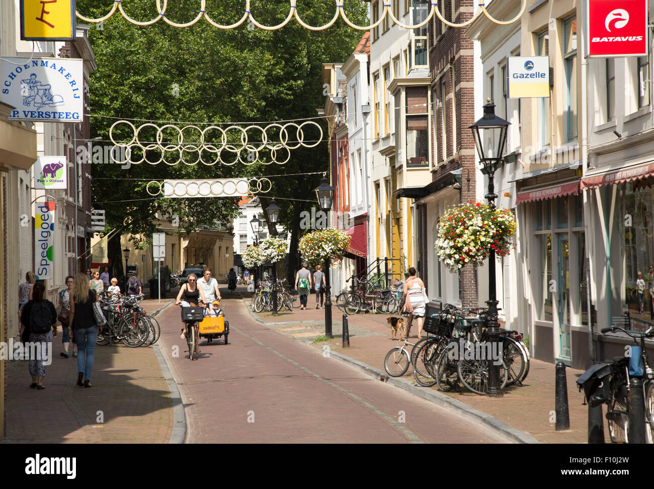 People walking and cycling in historic street central Utrecht ...