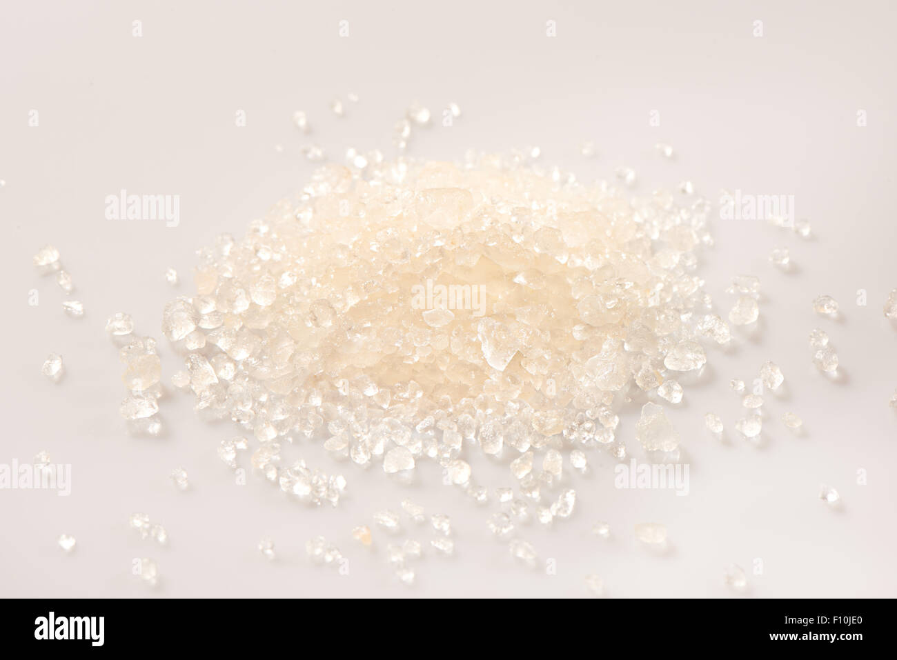 Pile of sea salt on white background Stock Photo - Alamy