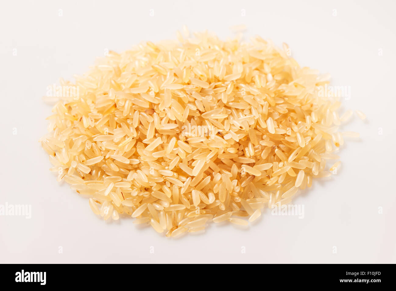 Pile of brown rice seeds isolated on the white background Stock Photo ...