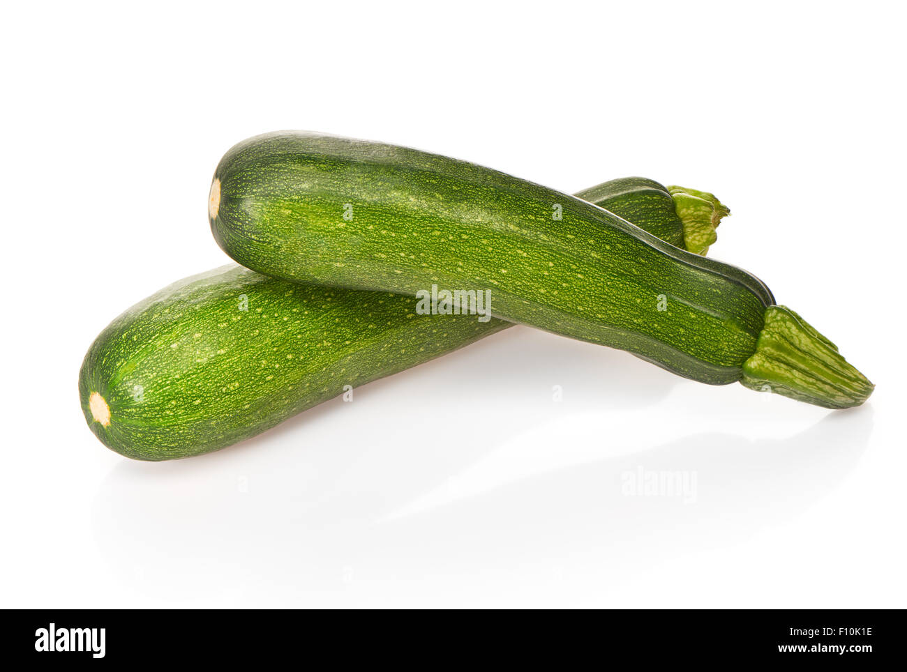 Two green zucchini isolated on white background Stock Photo - Alamy