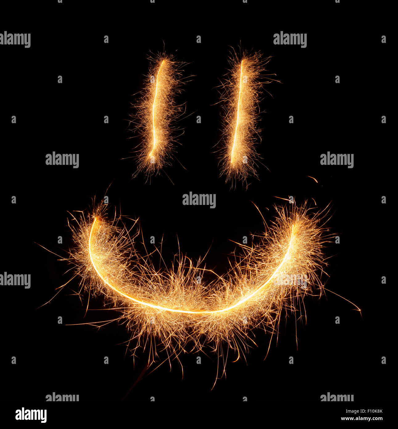 Happy weird smiling smiley drawn with sparkles isolated on black ...