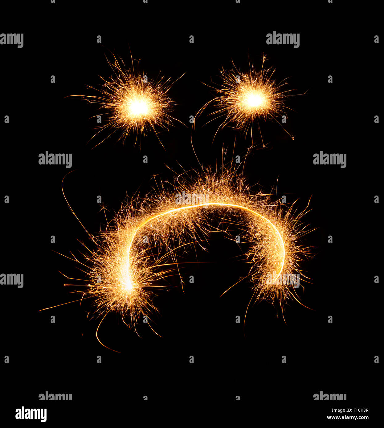 Upset weird sad smiley drawn with sparkles isolated on black background ...