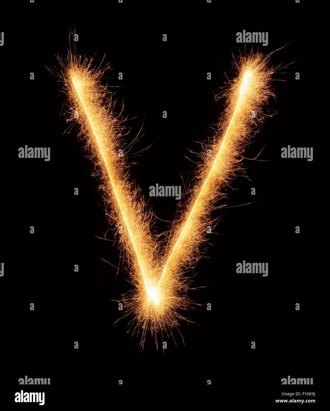 "V" letter drawn with bengali sparkles isolated on black background ...