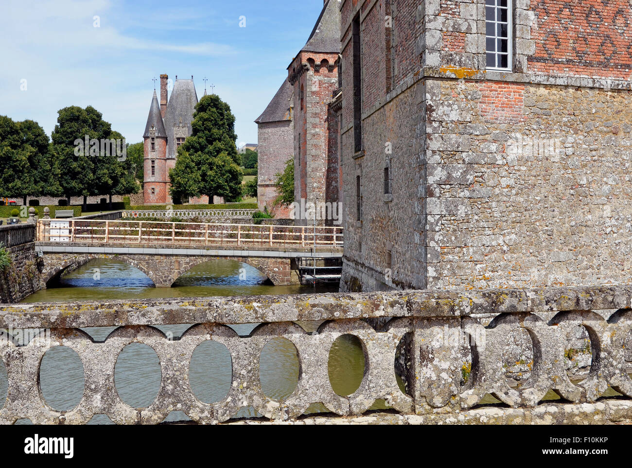 The moat at the Château de Carrouges, an unusual brick built castle in ...