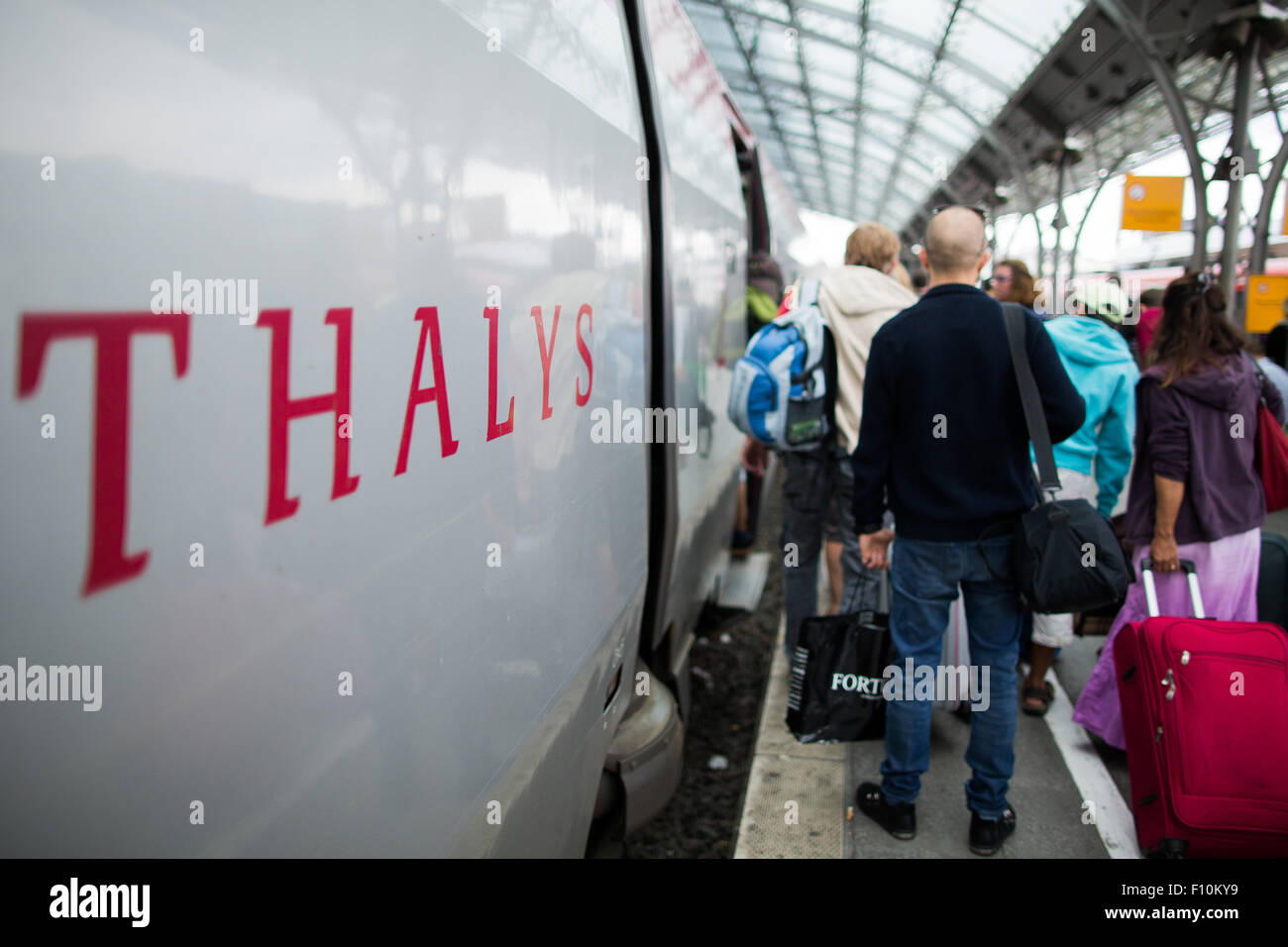Cologne, Germany. 24th Aug, 2015. Passengers board the Thalys railway ...