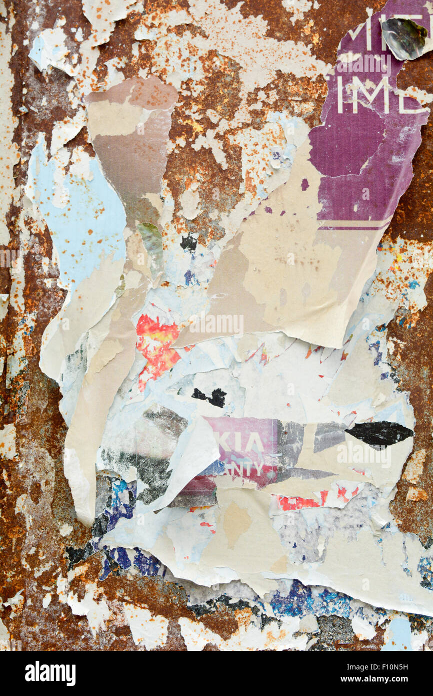 Peeling old decayed billboard posters - lots of layers of advertising ...