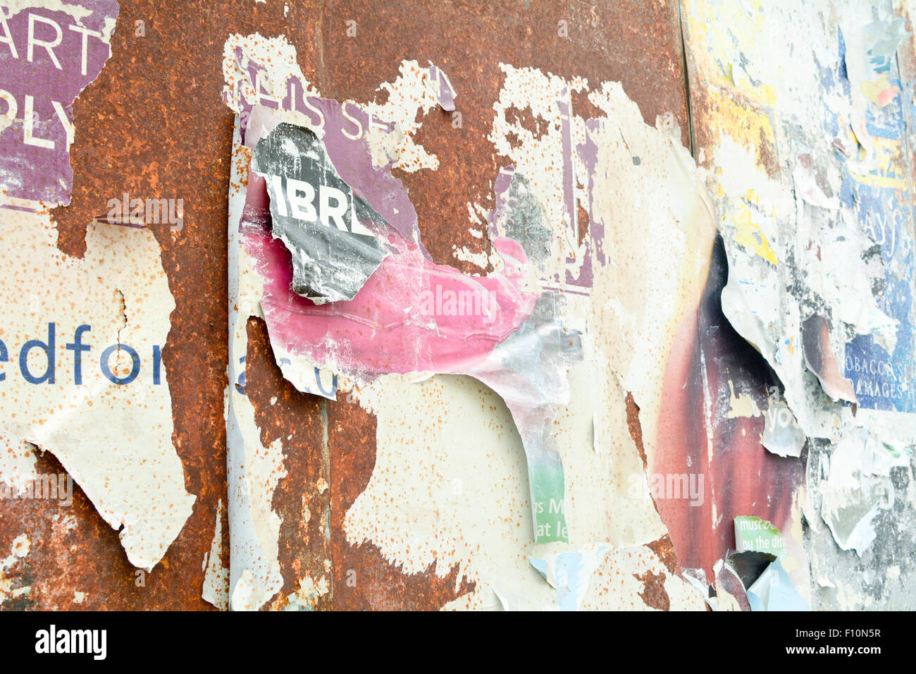 Peeling old decayed billboard posters - lots of layers of advertising ...